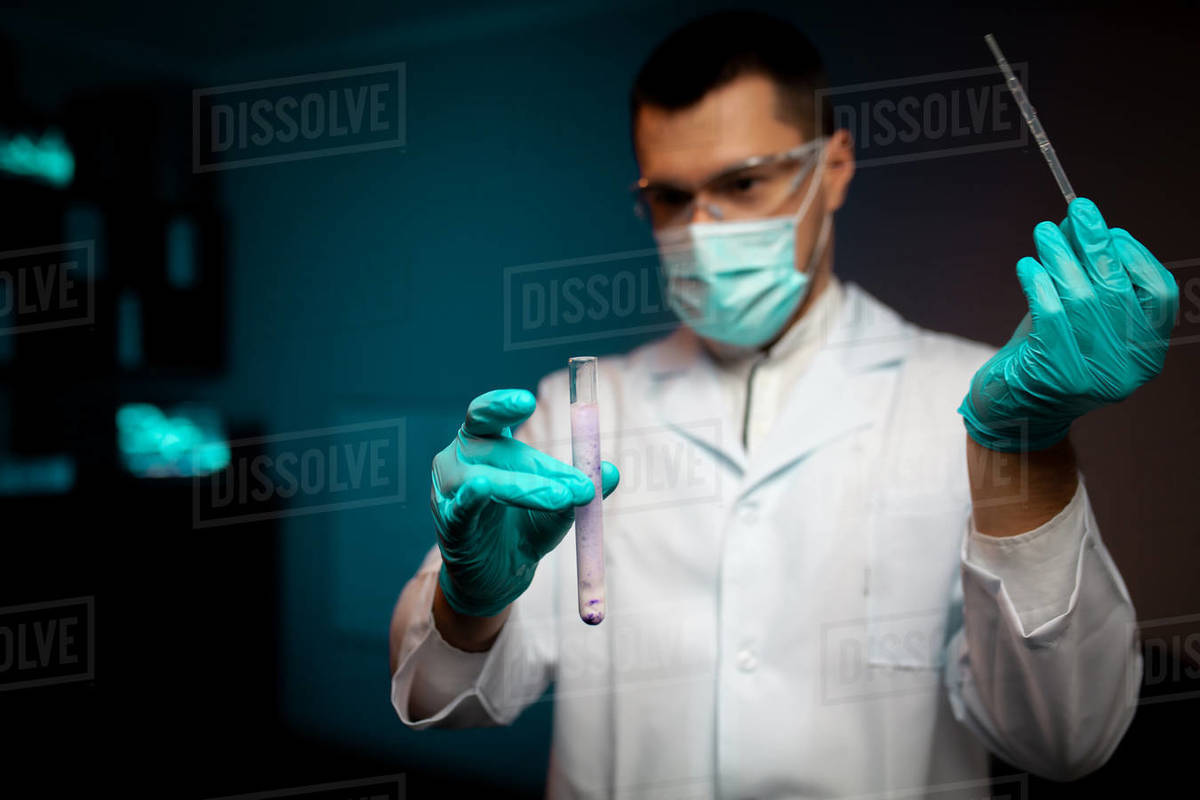 Man scientist or technologist doing experiment in a laboratory ...