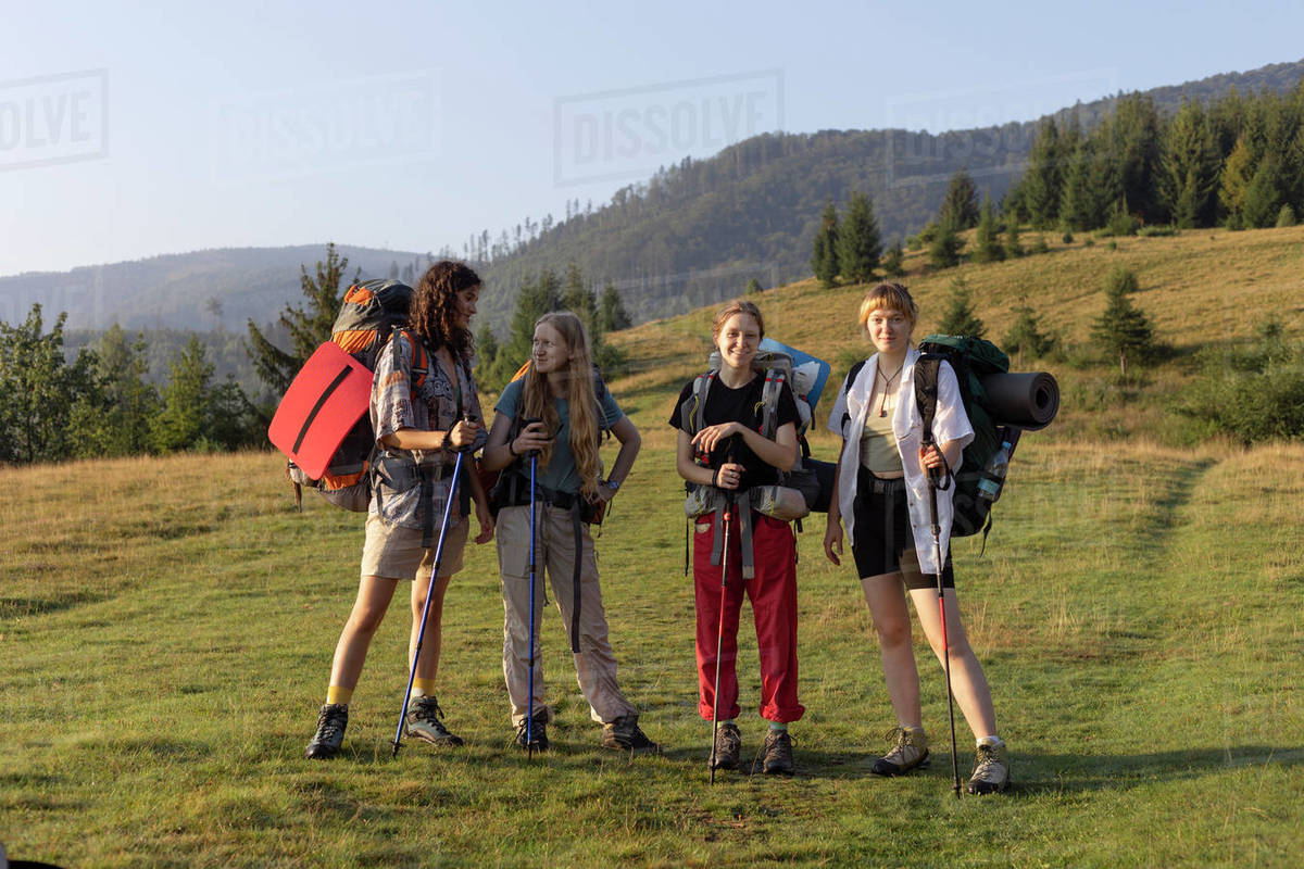 Group of happy girls tourists on a background in the mountains ...