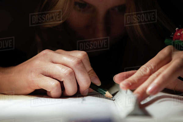 Woman fashion designer created sewing pattern close up. Dark lit image ...