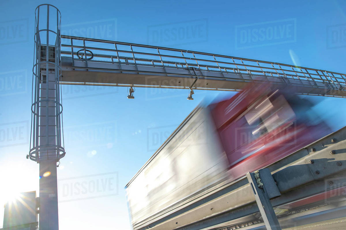 truck drive through the highway through the toll gate, toll charges ...