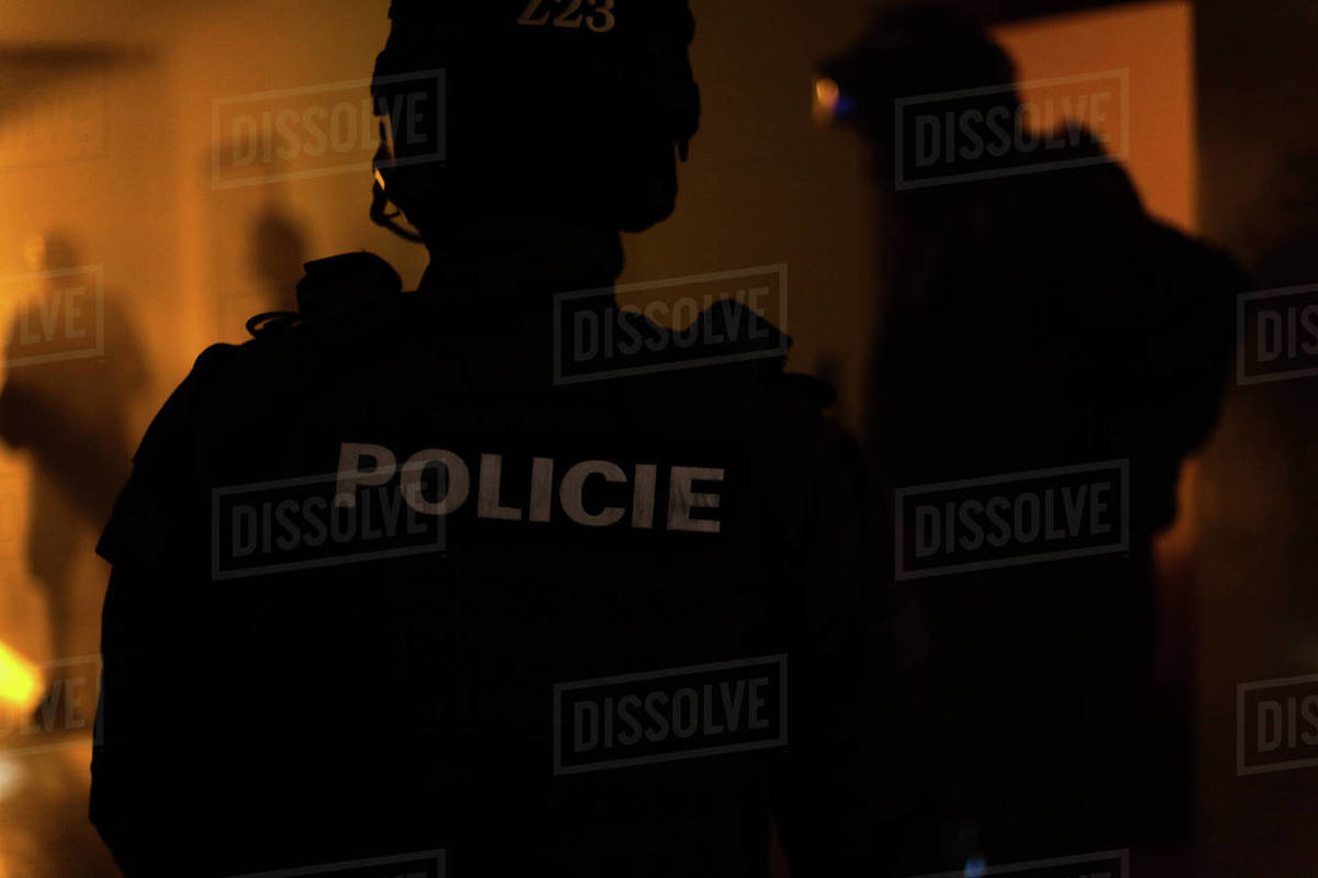 Silhouette of a police officer. Police commando in action, arresting ...