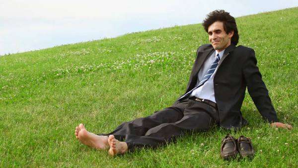 handsome man without shoes sitting on green grass - Stock Video Footage ...
