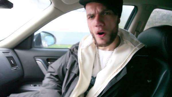 Adult rapper reads rap when sits in car on street, shown in motion - HD ...