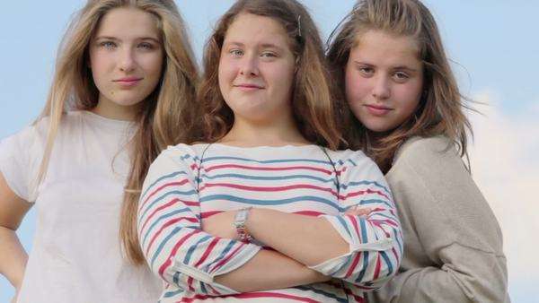 Three girls stand together and watch, closeup view at summer day - HD ...