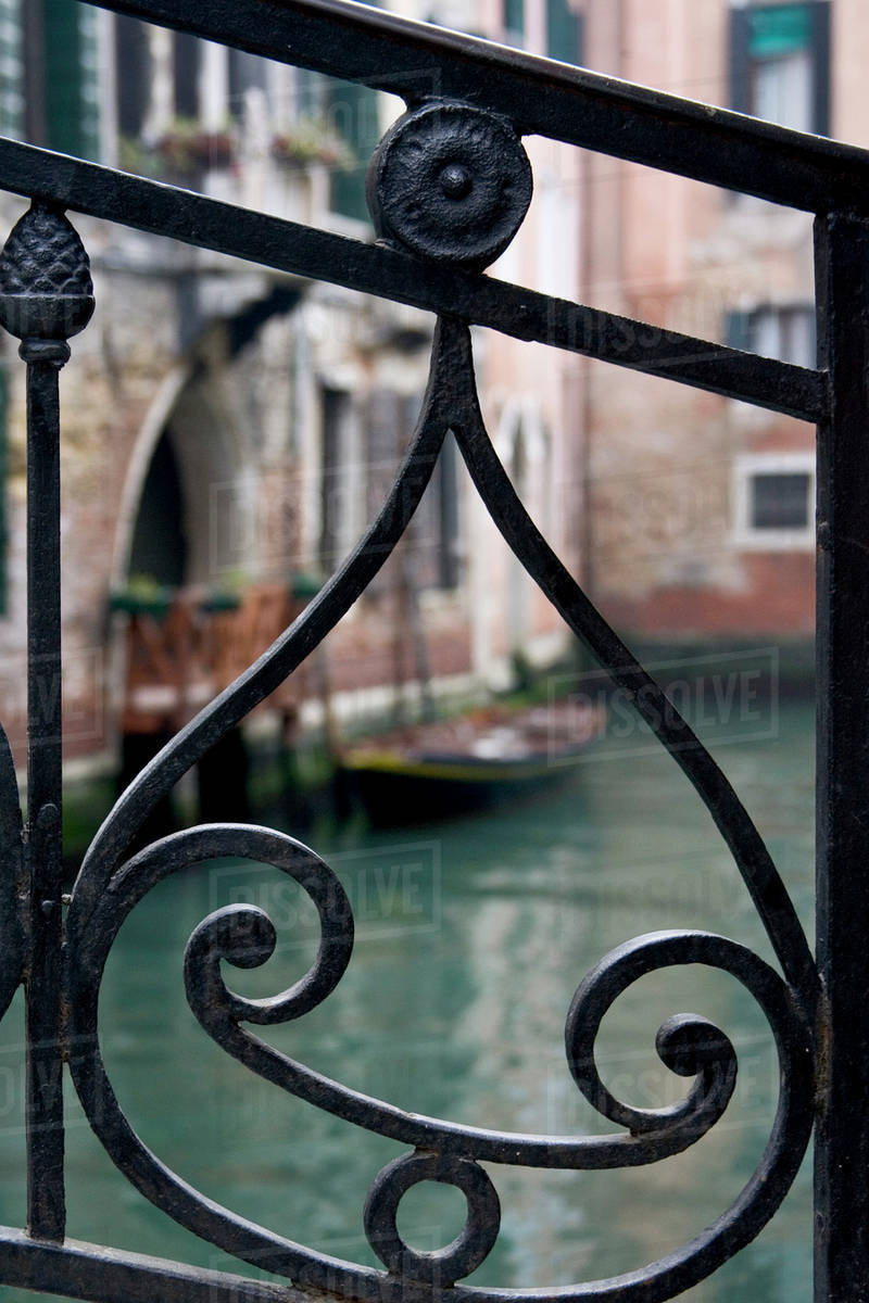 Italy, Venice. Stair railing metalwork design frames canal with gondola ...