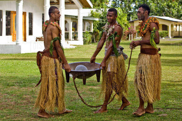 Fiji, Viti Levu, Viseisei. Three Fijian men in traditional dress with a ...