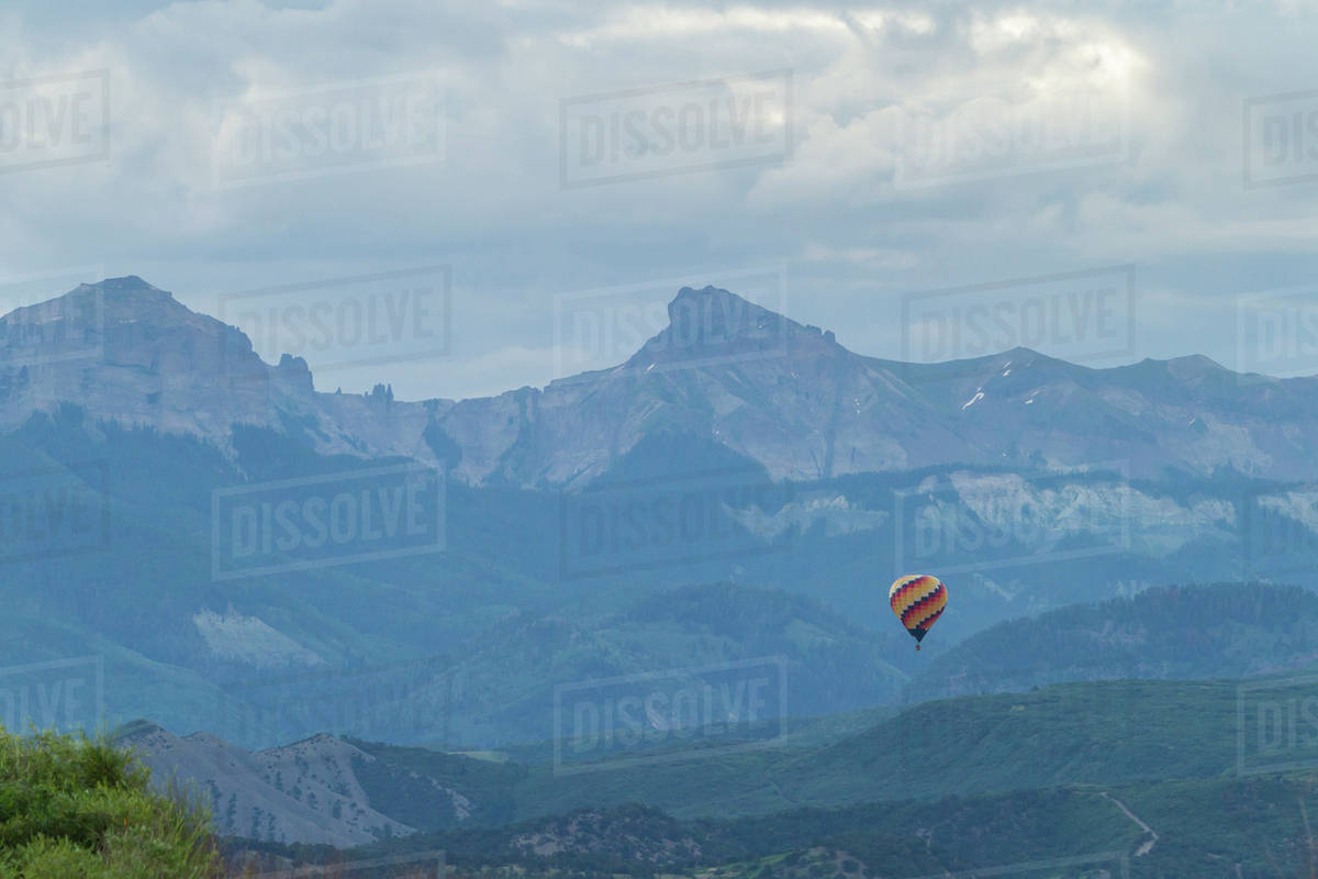 USA, Colorado, San Juan Mountains. Hot air balloon floats over ...