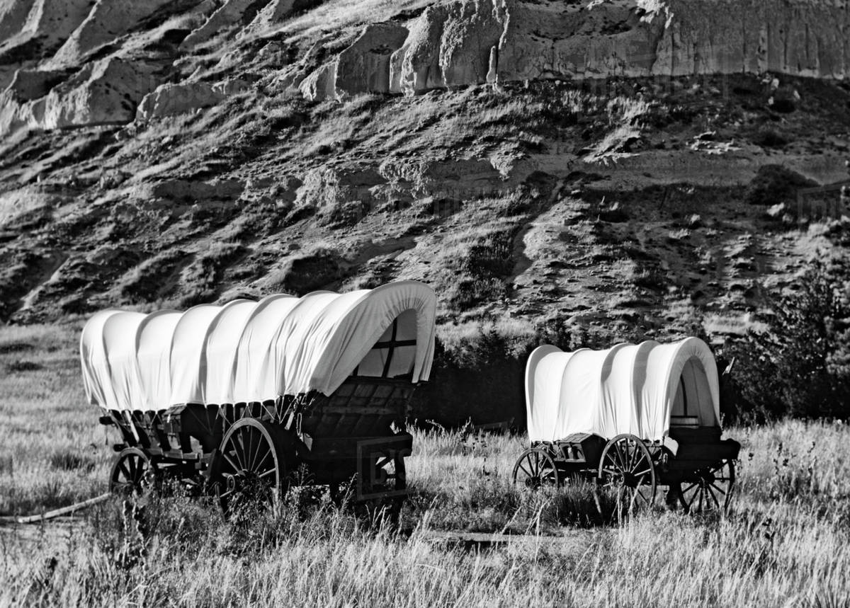 USA, Nebraska, Scotts Bluff National Monument. Covered wagons in field ...