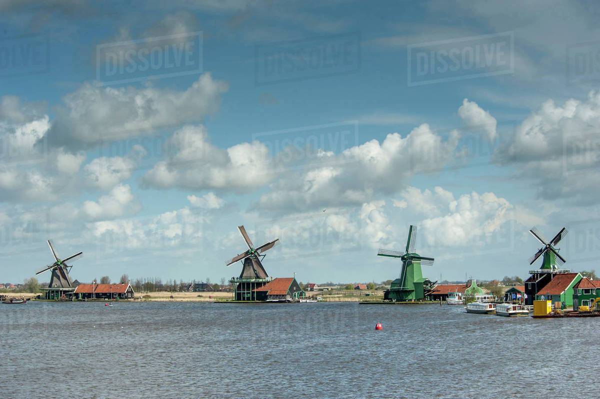 Windmills along a lake in a peaceful country scene - Royalty-free Stock ...