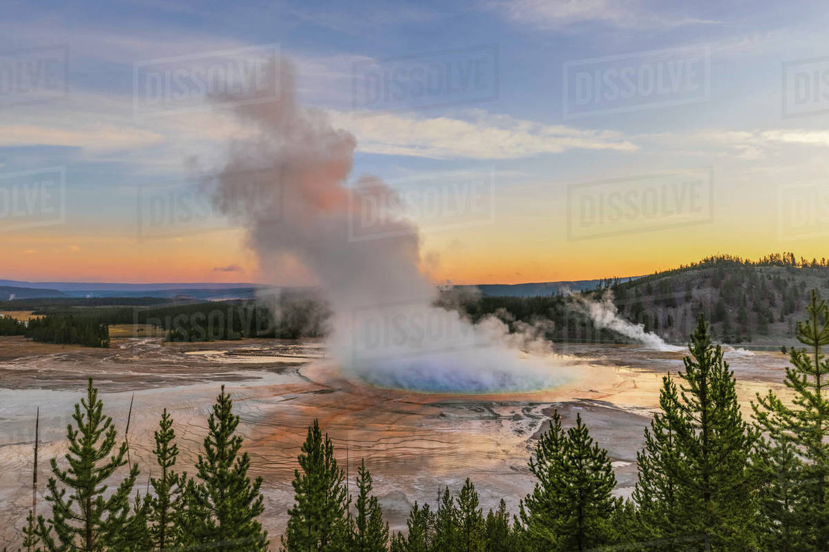 Elevated sunrise view of Grand Prismatic spring and colorful bacterial ...