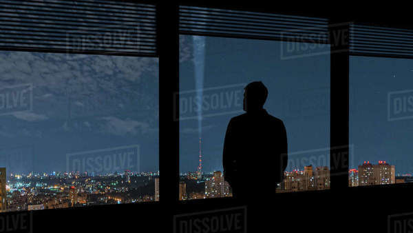The man standing near the window on the cityscape background - Stock ...