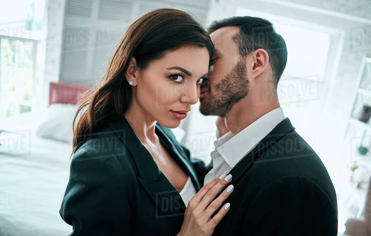 The woman and man in suits hug in the room - Royalty-free Stock Photo ...