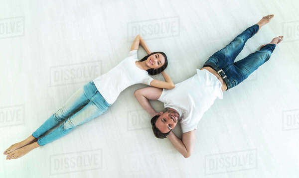 The happy man and a woman laying on the floor. view from above ...