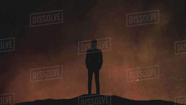 The human silhouette standing on a night cloudy background - Stock ...