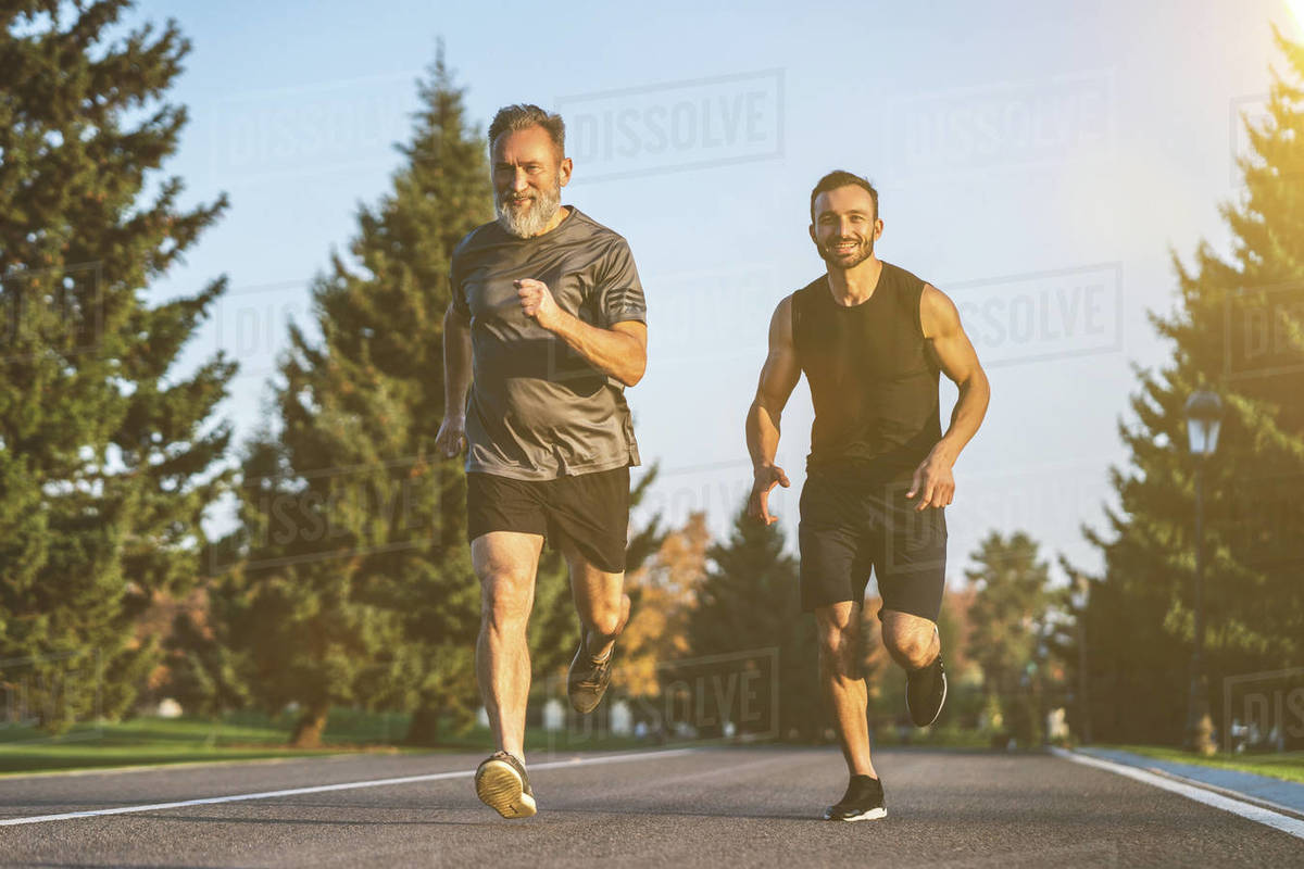 The happy father and a son running on the park road - Royalty-free ...