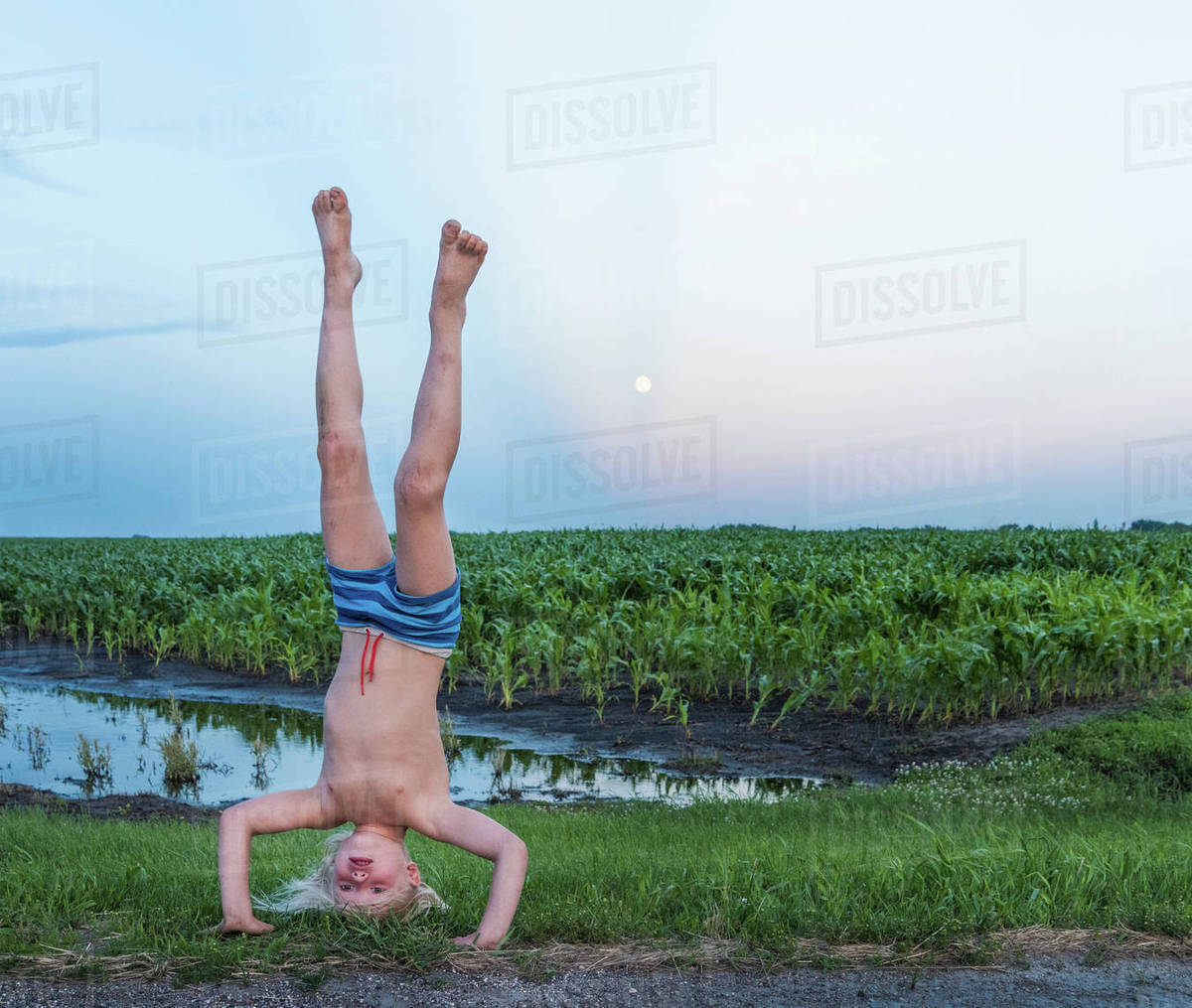 Boy wearing shorts doing handstand in rural area - Royalty-free Stock ...