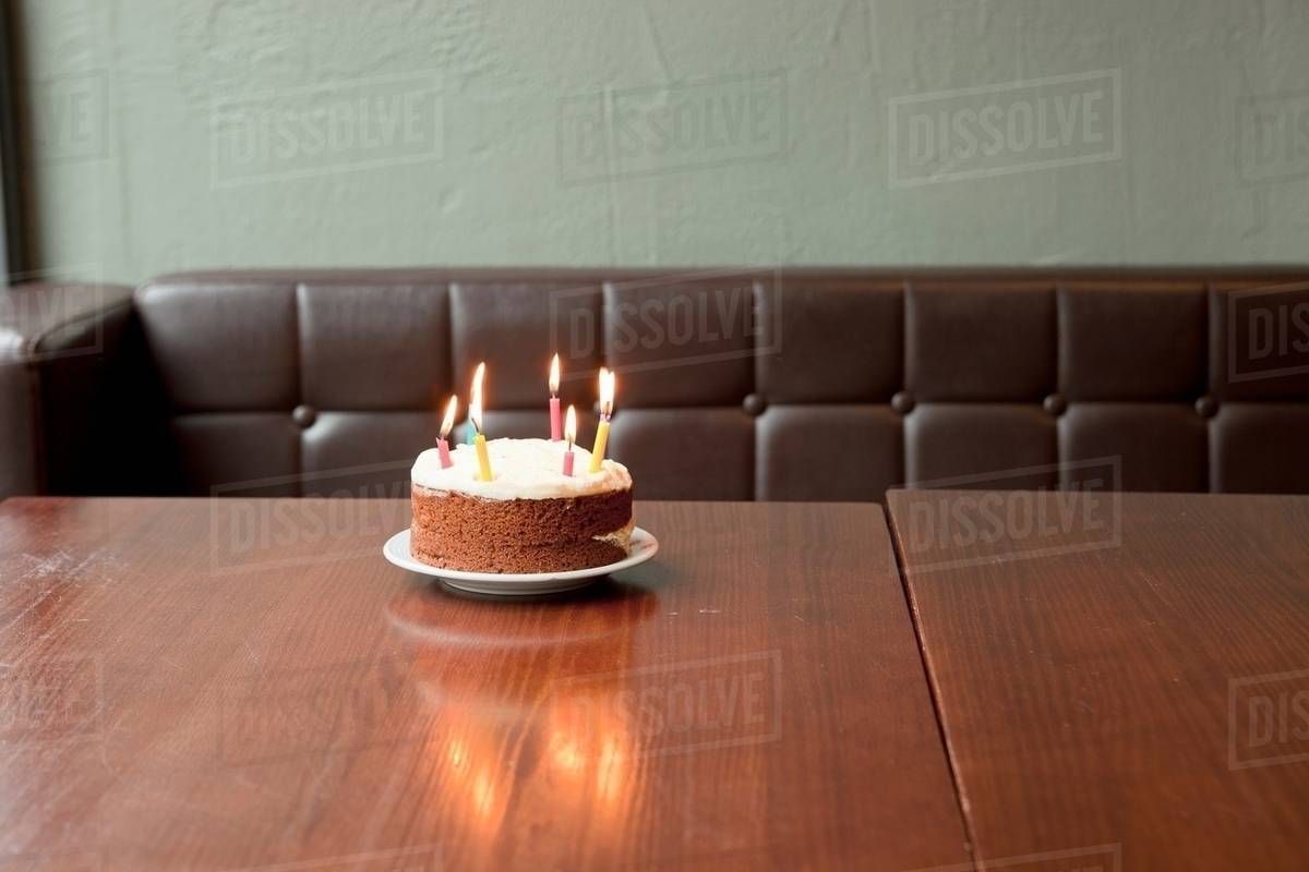 Birthday cake on table in restaurant - Royalty-free Stock Photo | Dissolve
