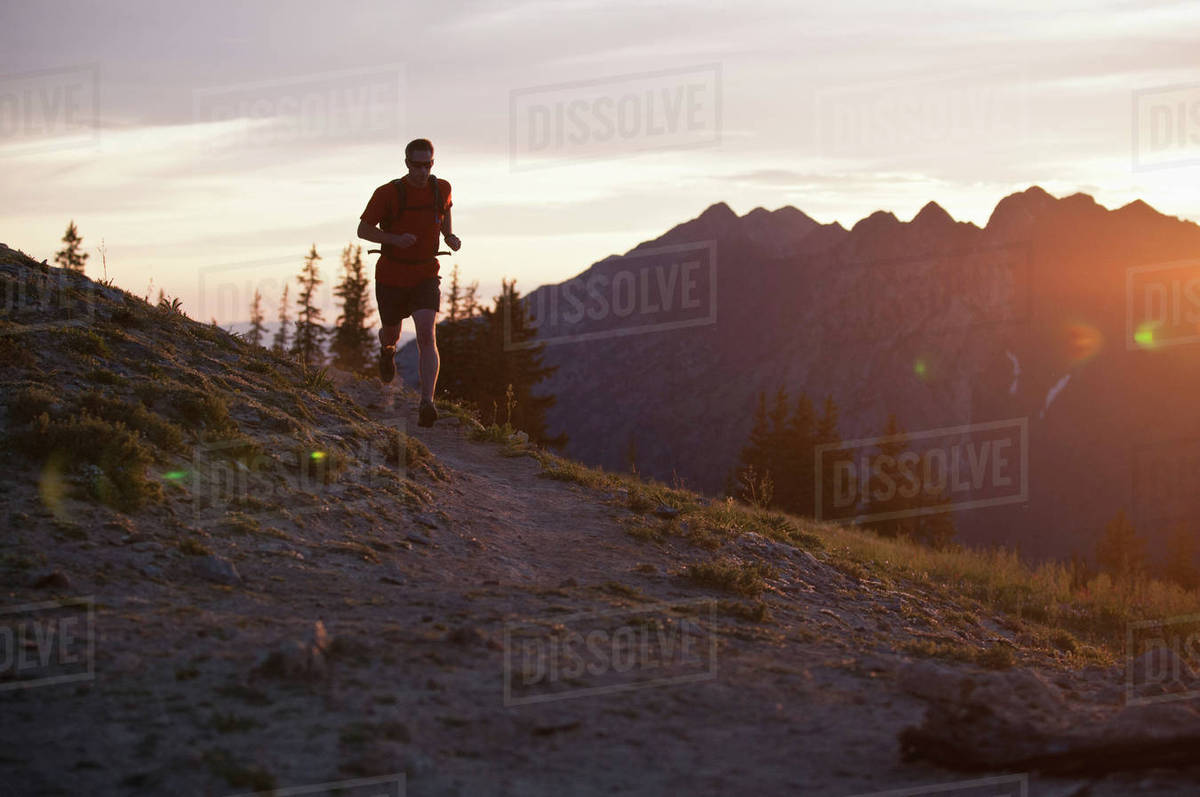 Man running on dirt path - Royalty-free Stock Photo | Dissolve