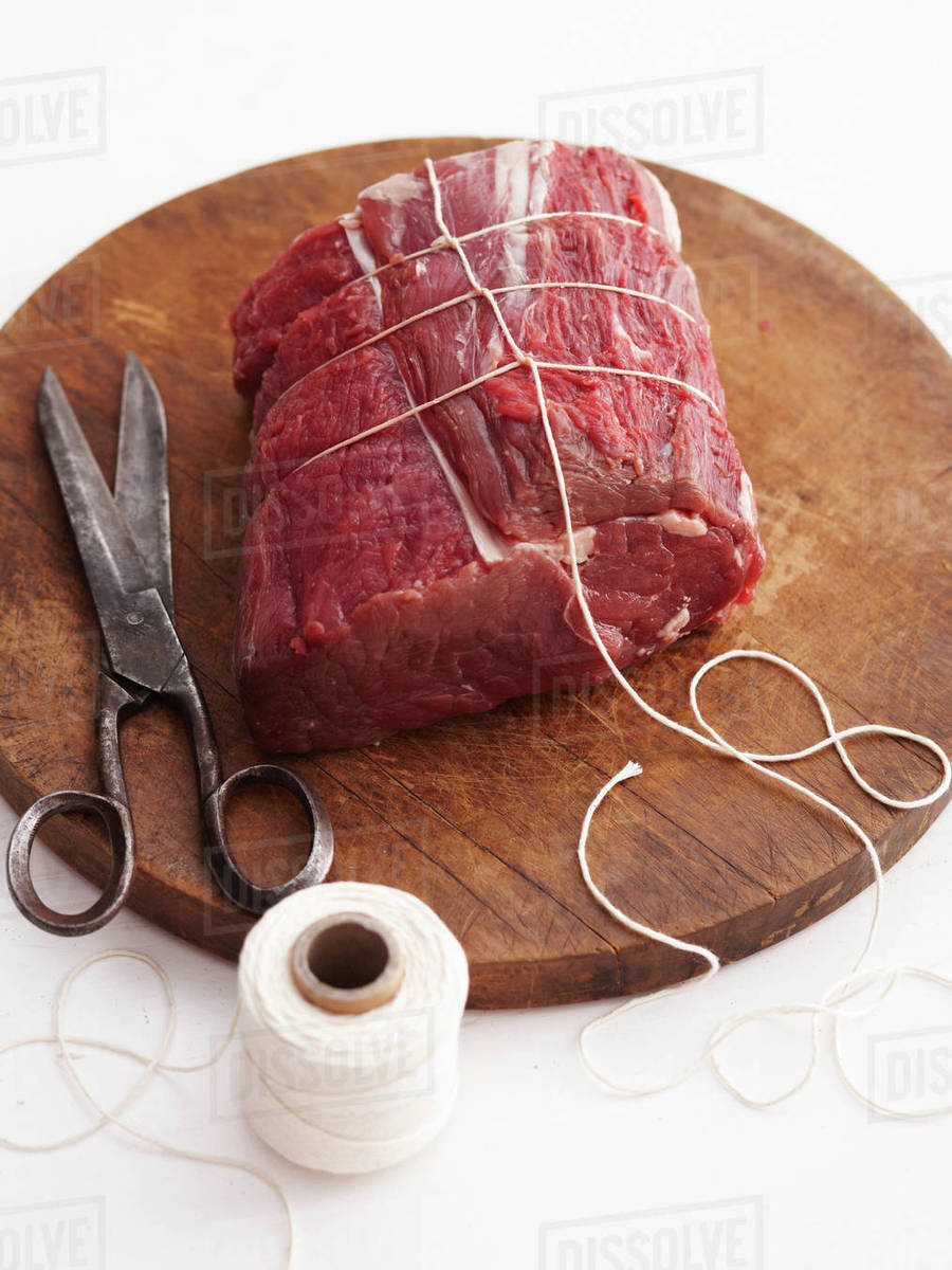 Twine wrapping raw beef - Royalty-free Stock Photo | Dissolve