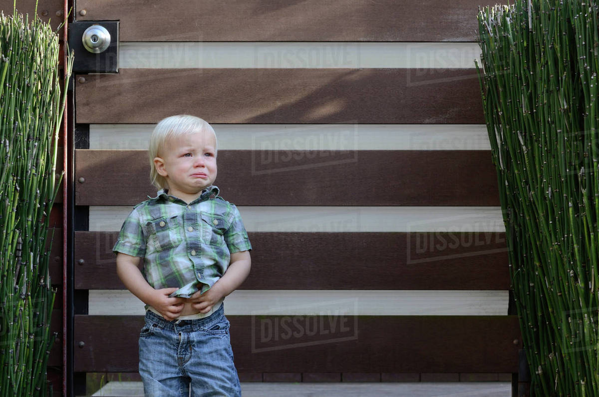 Toddler boy crying outdoors - Royalty-free Stock Photo | Dissolve