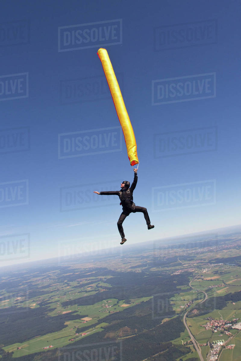 Woman skydiving with parachute - Royalty-free Stock Photo | Dissolve