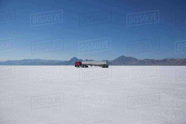 Truck driving in desert landscape - Royalty-free Stock Photo | Dissolve