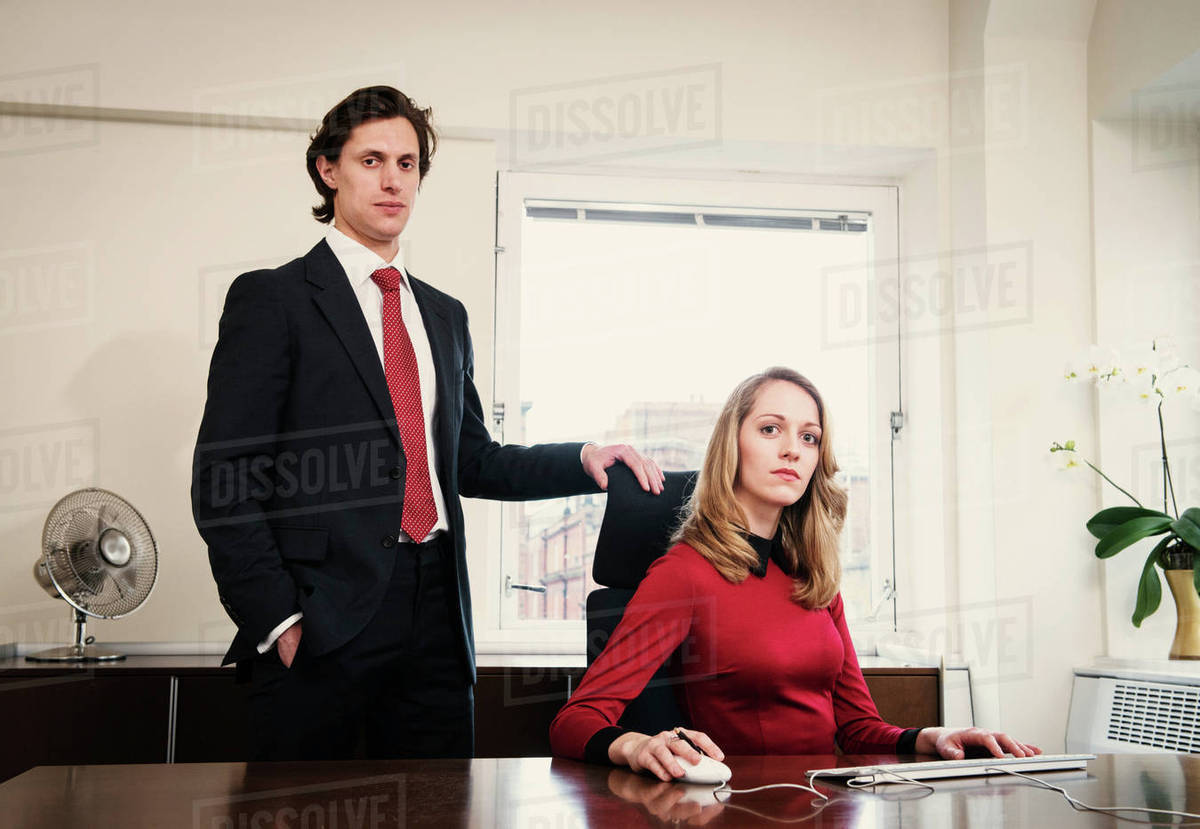 Female manager at desk with male colleague - Royalty-free Stock Photo ...