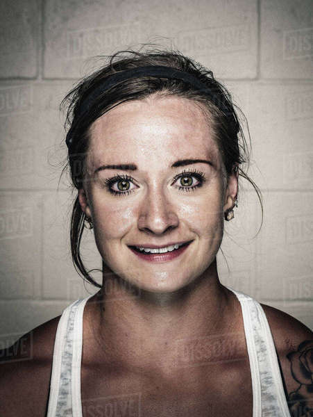 Portrait of sweaty smiling young woman after workout - Royalty-free ...