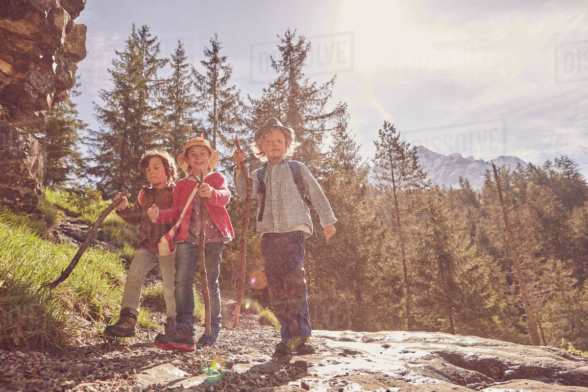 Three children exploring forest - Royalty-free Stock Photo | Dissolve