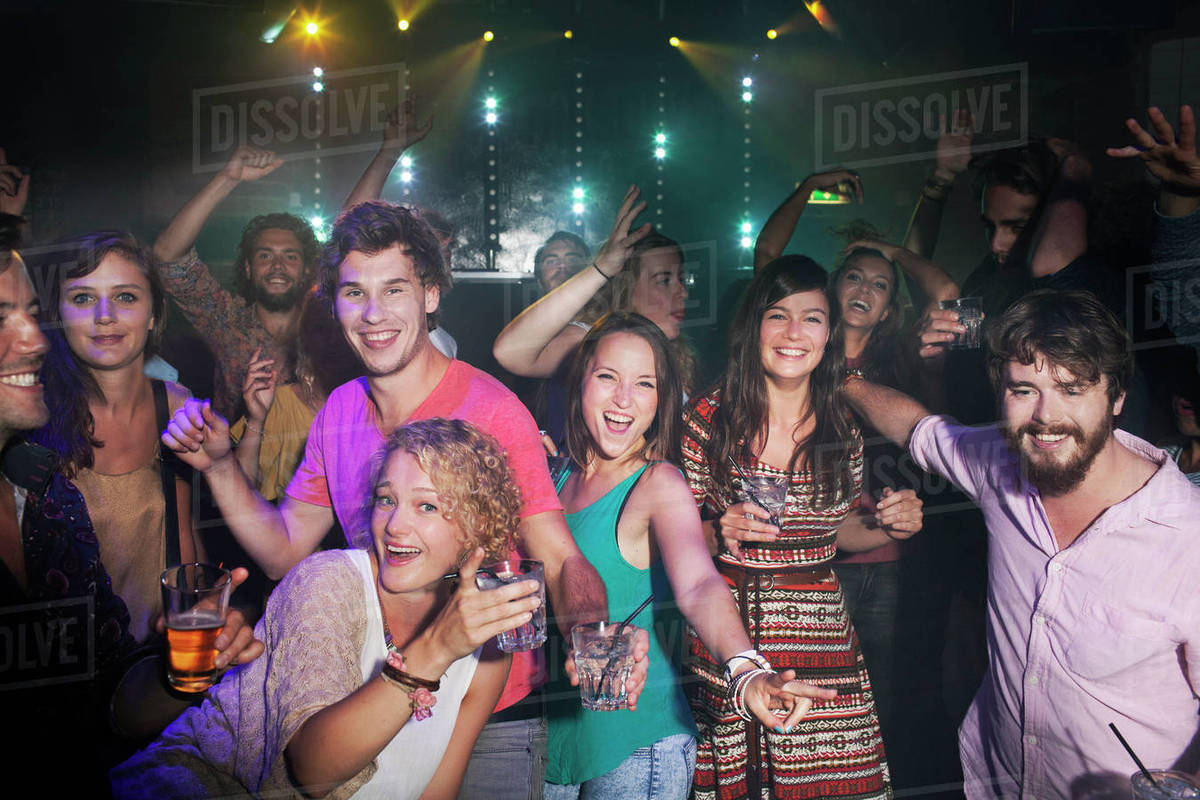 Group of friends celebrating in club - Royalty-free Stock Photo | Dissolve