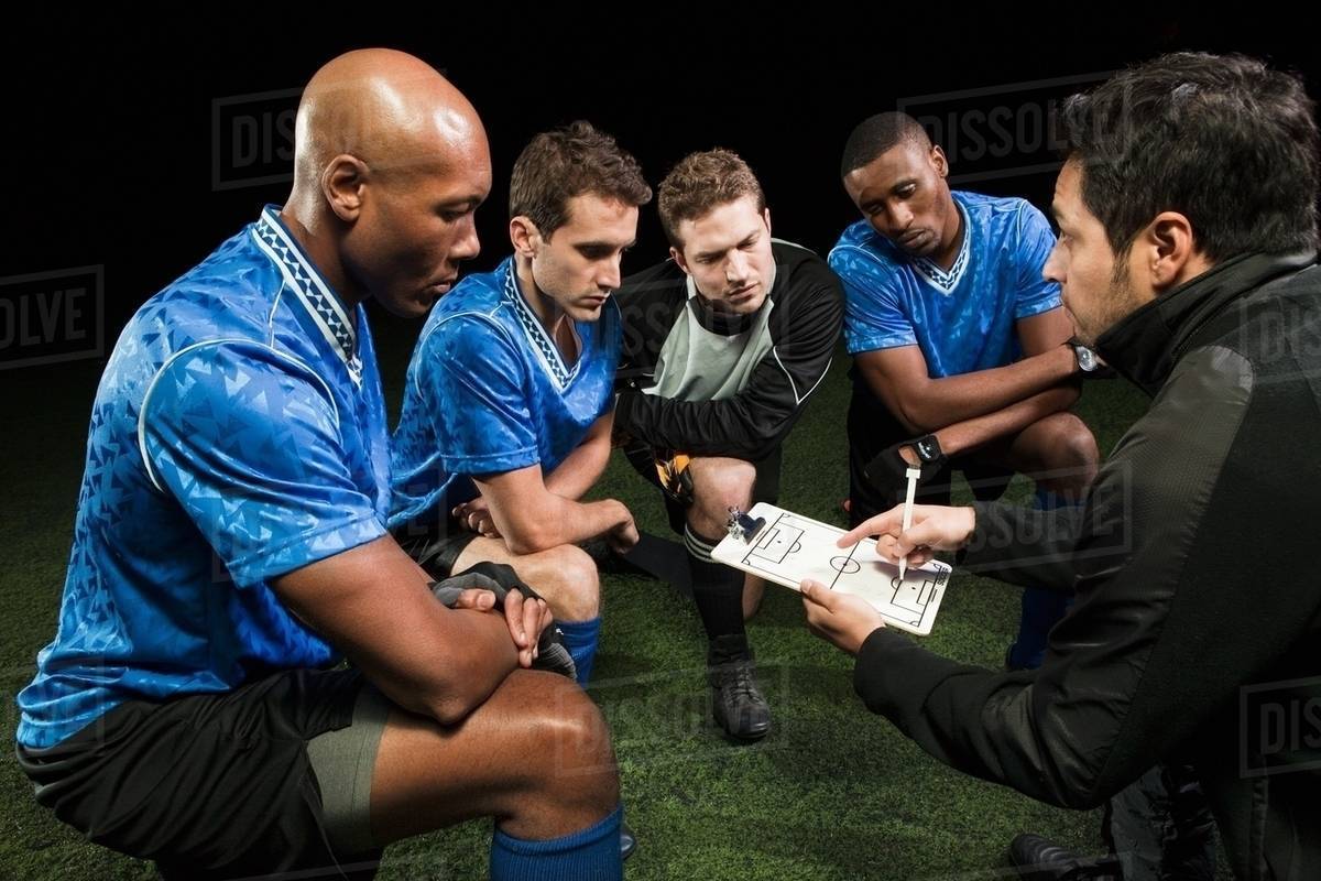 Soccer team planning game with coach - Royalty-free Stock Photo | Dissolve