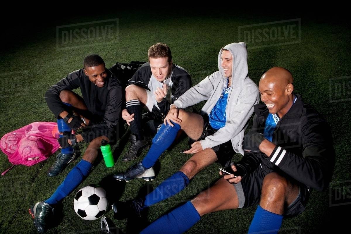 Soccer team resting on pitch after game - Royalty-free Stock Photo ...