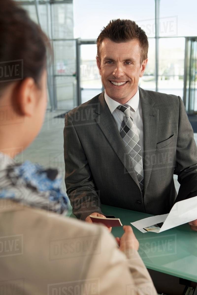 Businessman checking in at airport - Royalty-free Stock Photo | Dissolve