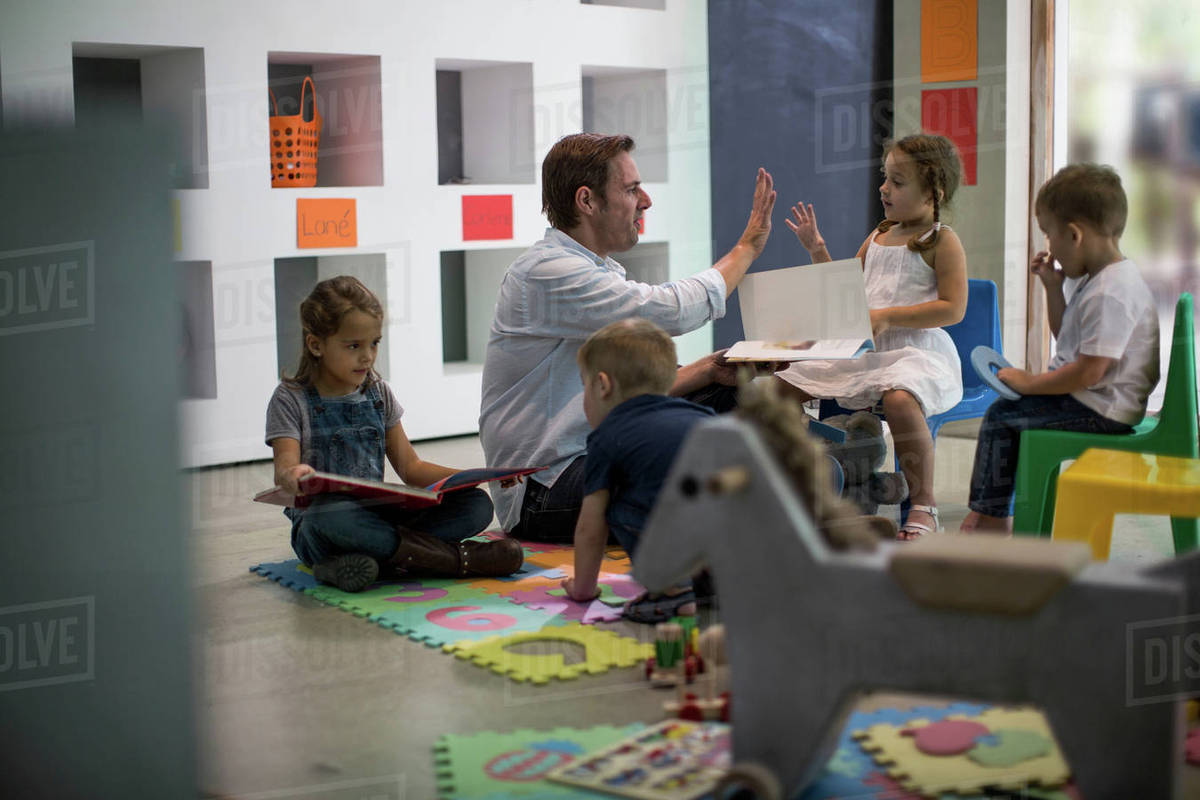 Teacher reading to children - Stock Photo - Dissolve