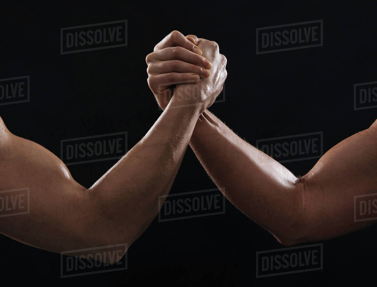 Arms of muscular women gripping hands - Royalty-free Stock Photo | Dissolve