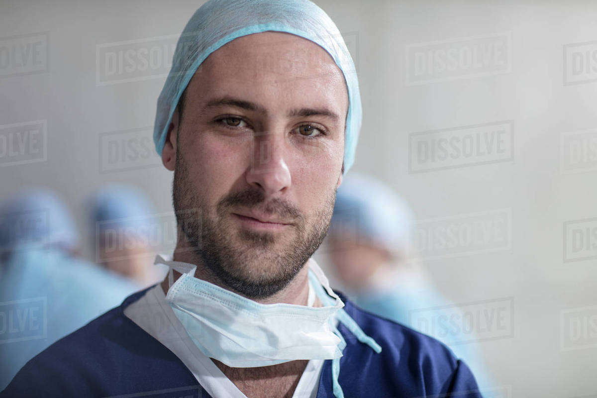 Portrait of male surgeon wearing scrubs and surgical mask - Royalty ...