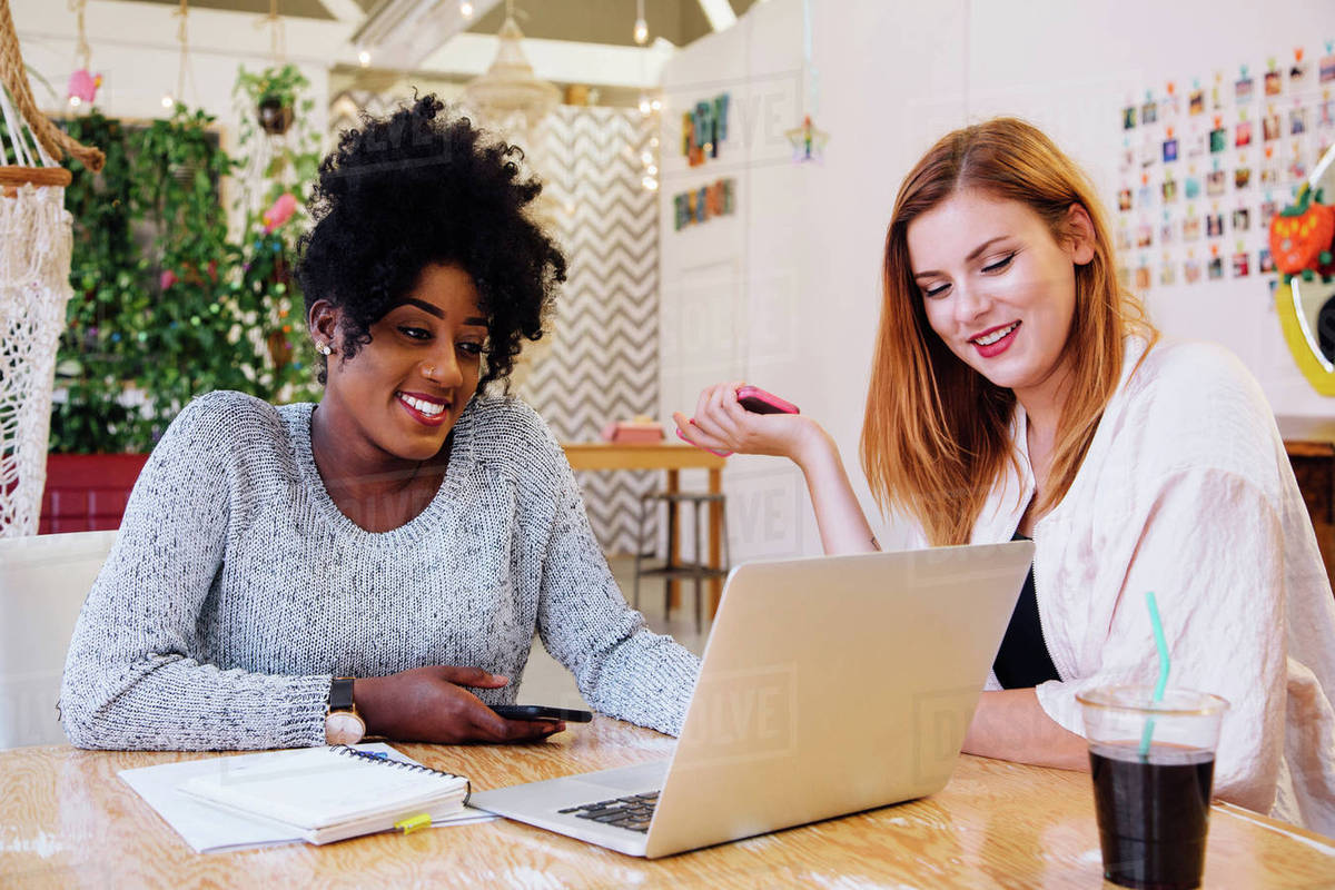 Colleagues in office using laptop together - Royalty-free Stock Photo ...
