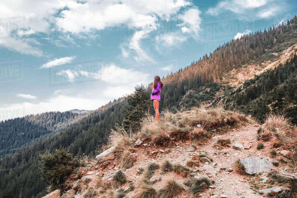 Young woman looking out over mountain forest landscape, Draja, Vaslui ...