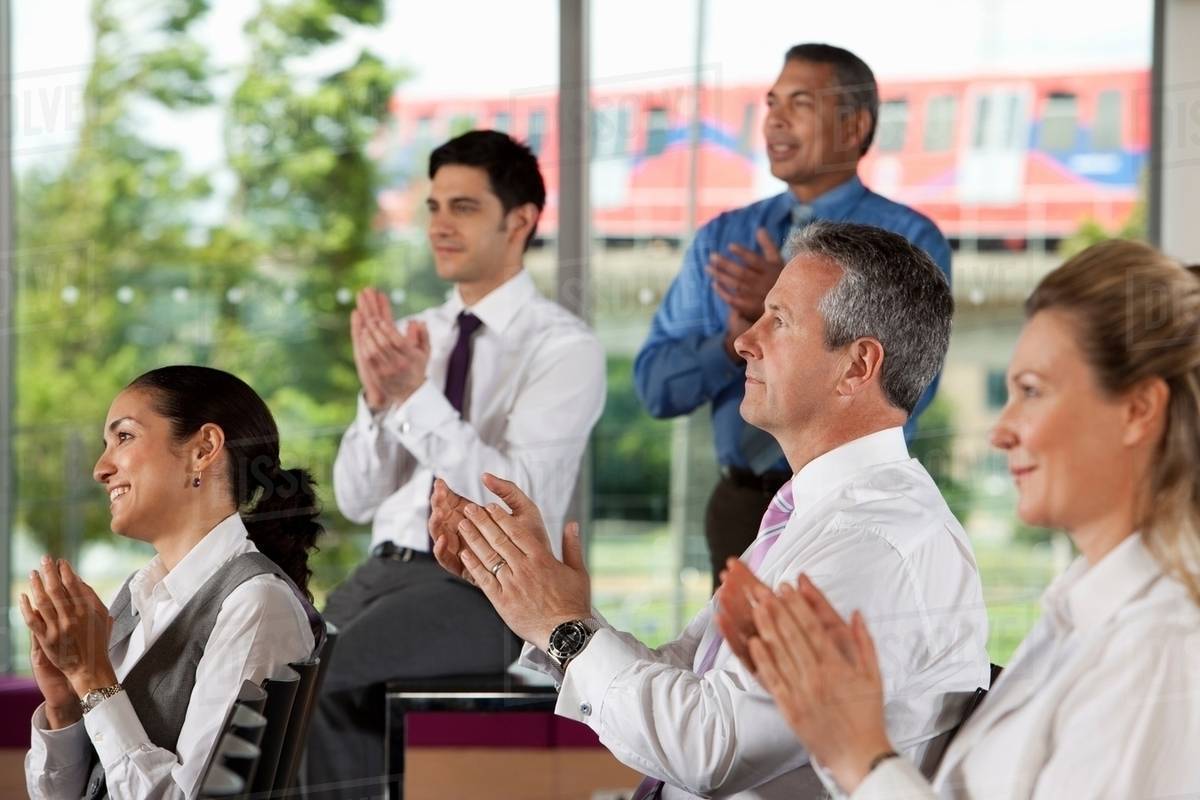 Businesspeople clapping at meeting - Royalty-free Stock Photo | Dissolve