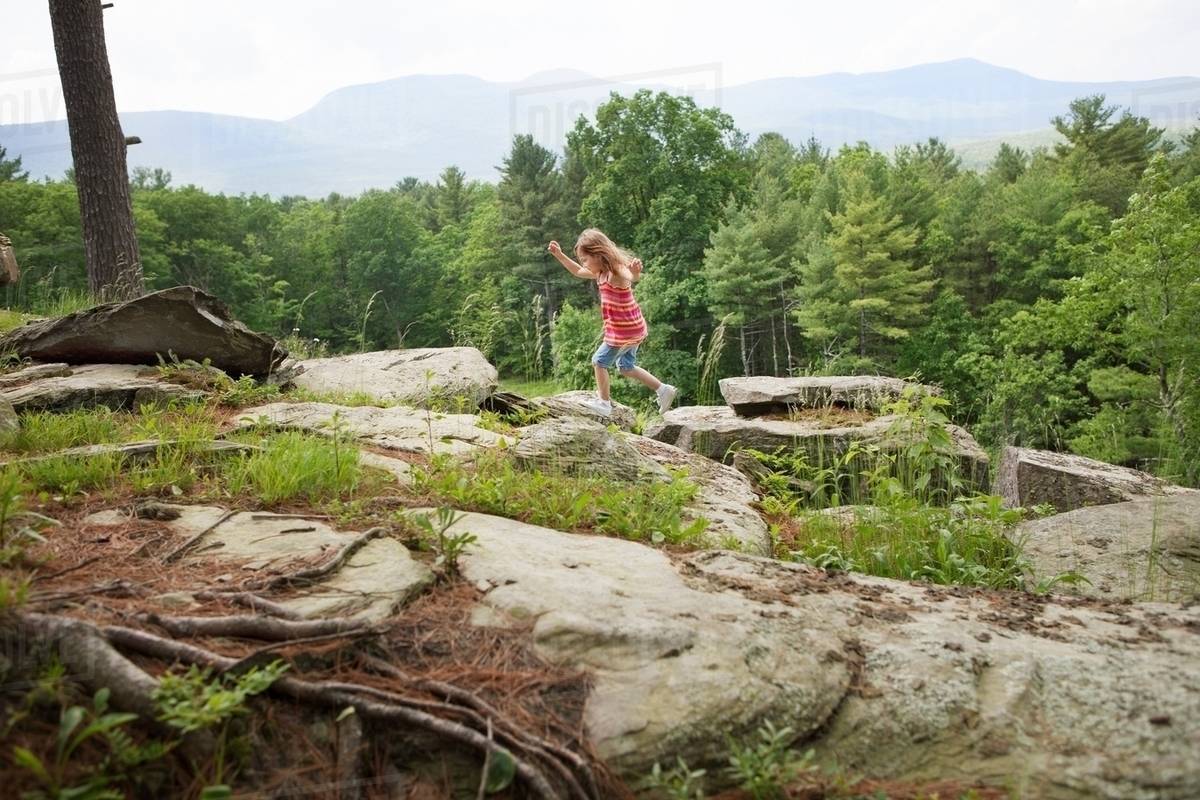 Girl playing on rocks - Royalty-free Stock Photo | Dissolve
