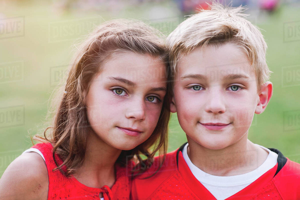 Portrait of boy and girl looking at camera - Stock Photo - Dissolve