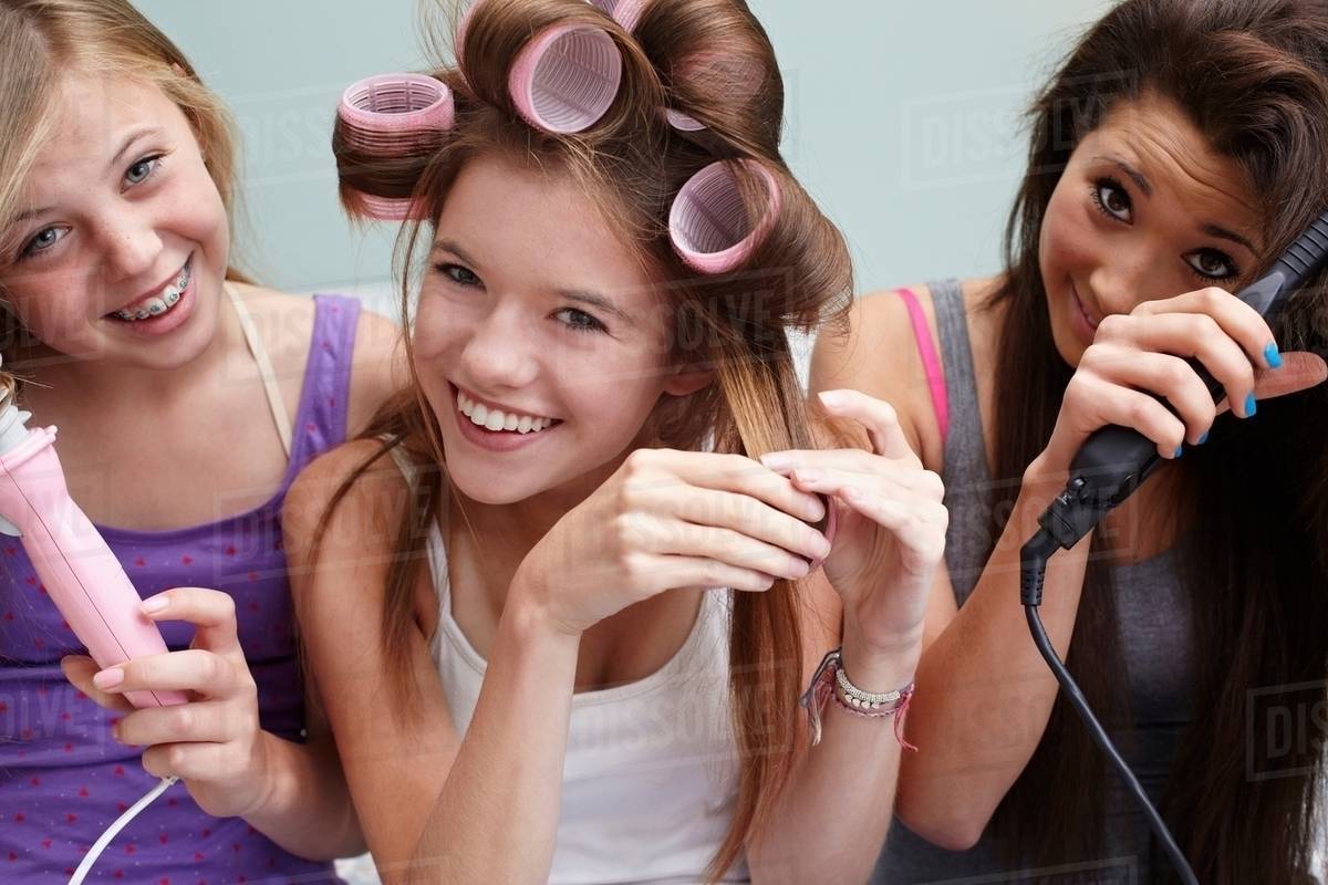 Teenage girls styling their hair - Royalty-free Stock Photo | Dissolve