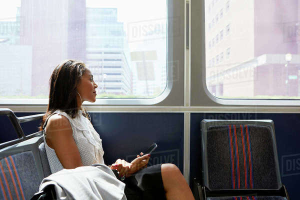Businesswoman on train - Stock Photo - Dissolve