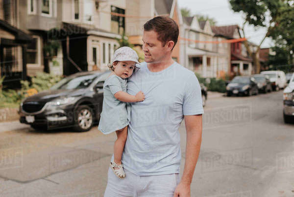 Man carrying daughter on street - Royalty-free Stock Photo | Dissolve