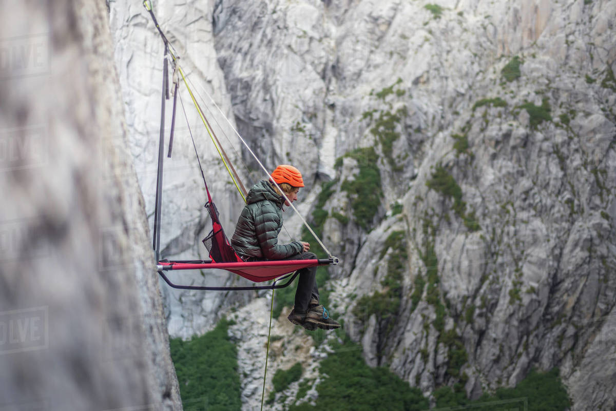 Woman sitting on portaledge, Cochamo, Los Lagos, Chile - Stock Photo ...