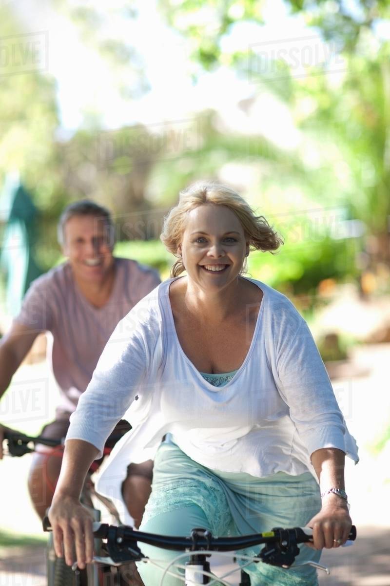 Couple riding mountain bikes together - Royalty-free Stock Photo | Dissolve