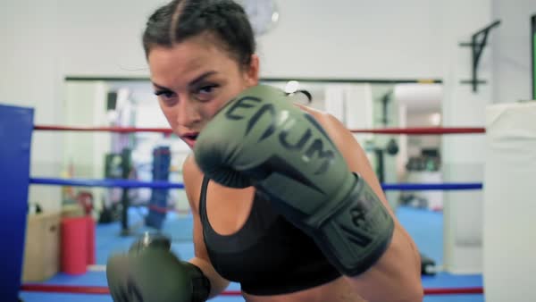 Woman training boxing in boxing ring - Stock Video Footage - Dissolve