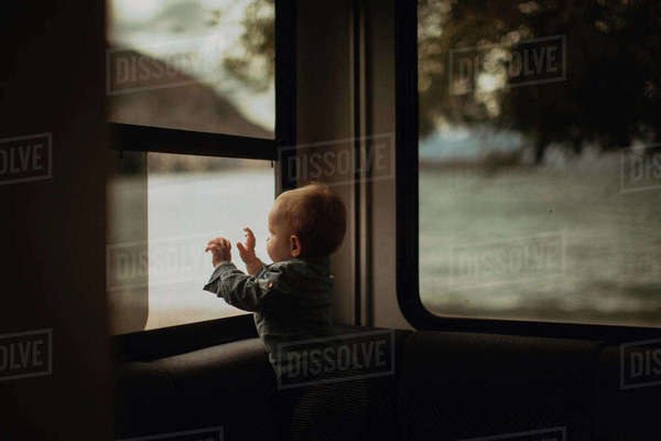 Baby looking out window of motorhome, Wanaka, Taranaki, New Zealand ...