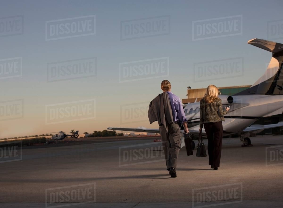 Business people on airplane runway - Royalty-free Stock Photo | Dissolve