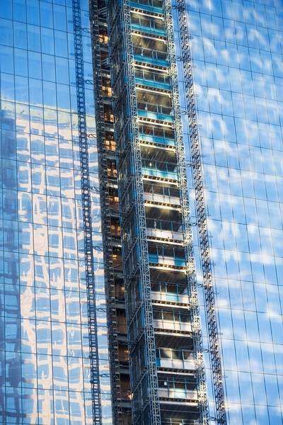 Scaffolding on urban skyscraper - Stock Photo - Dissolve